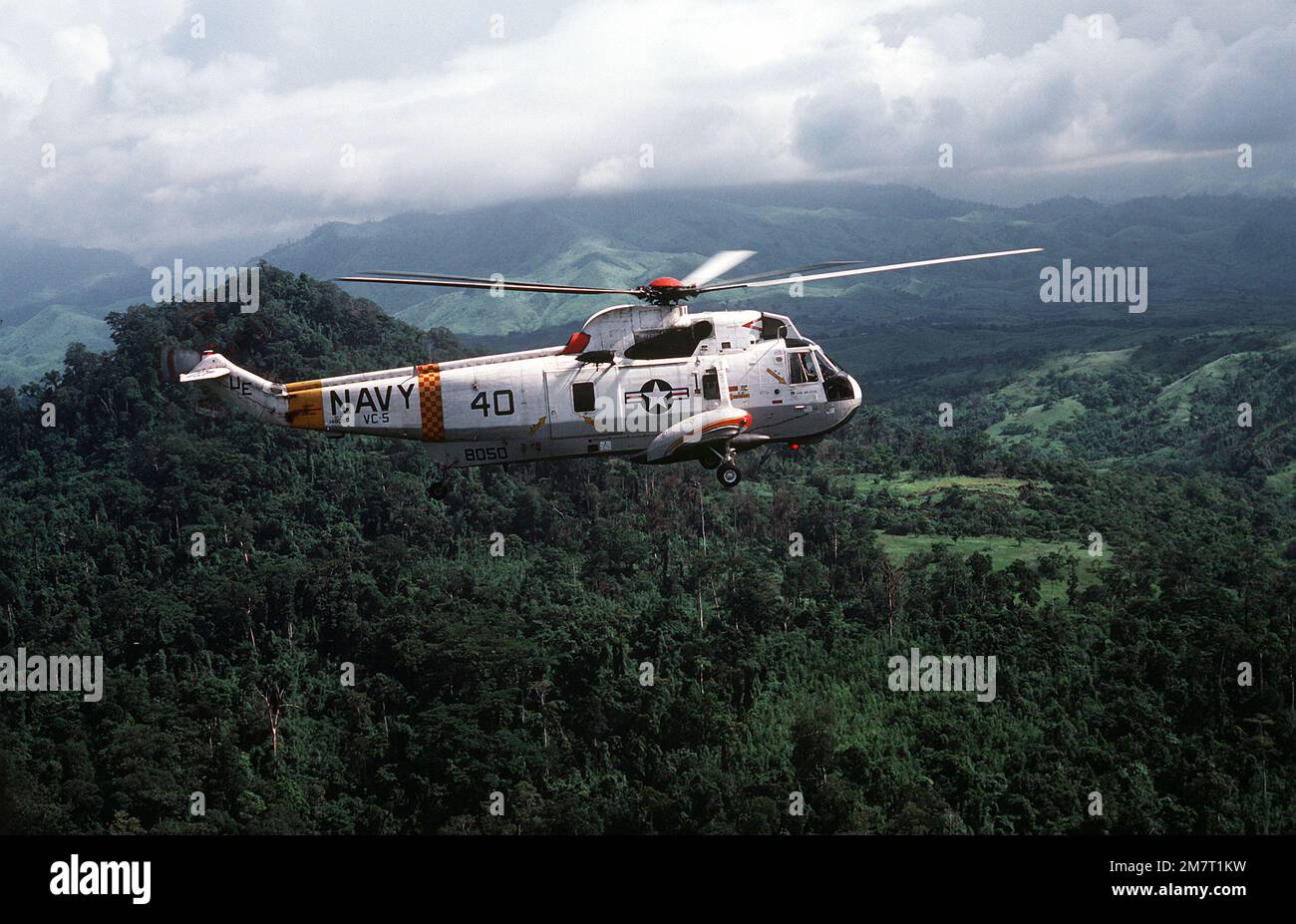 An air-to-air right side view of an SH-3A Sea King helicopter from ...