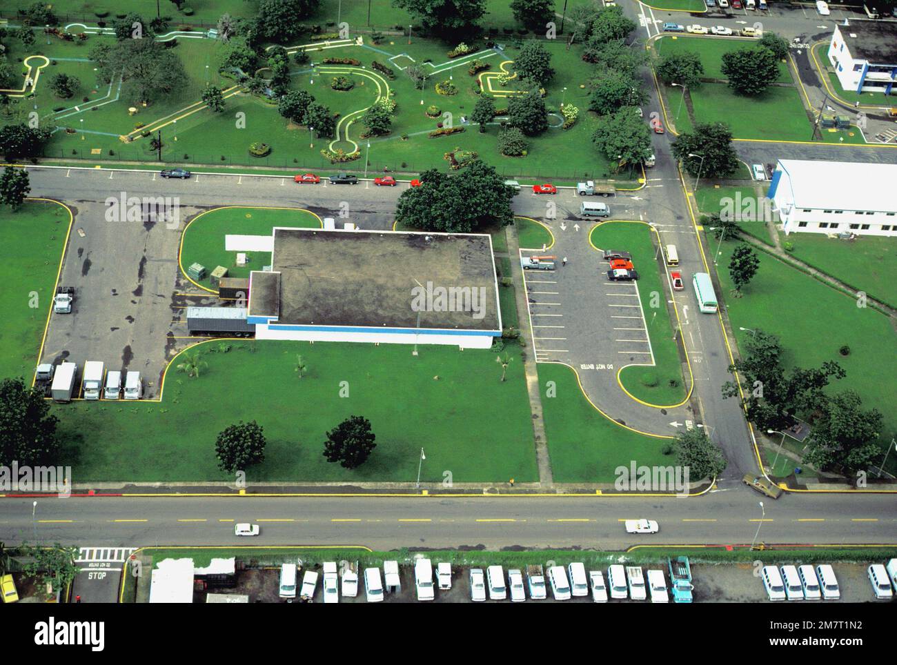 An aerial view of a building across from a park, top. Base: Naval ...