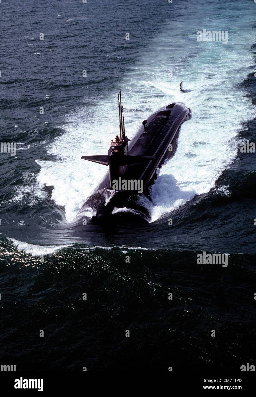 A port bow view of the nuclear-powered attack submarine USS HADDOCK (SSN-621) underway with crew ...