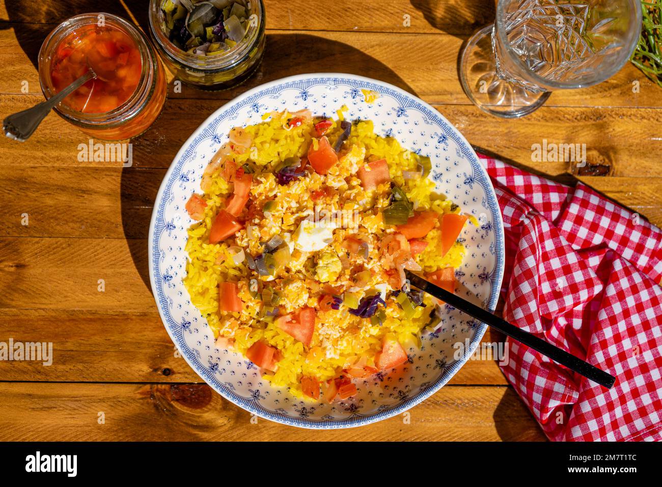 Deep plate on a wooden table with a homemade shredded chicken, rice and ...