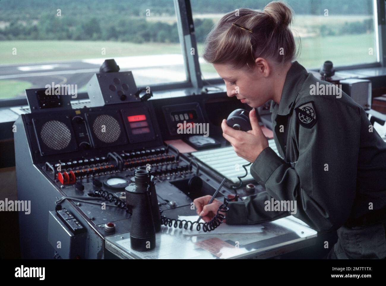A female U.S. Army air traffic controller gives instructions to ...