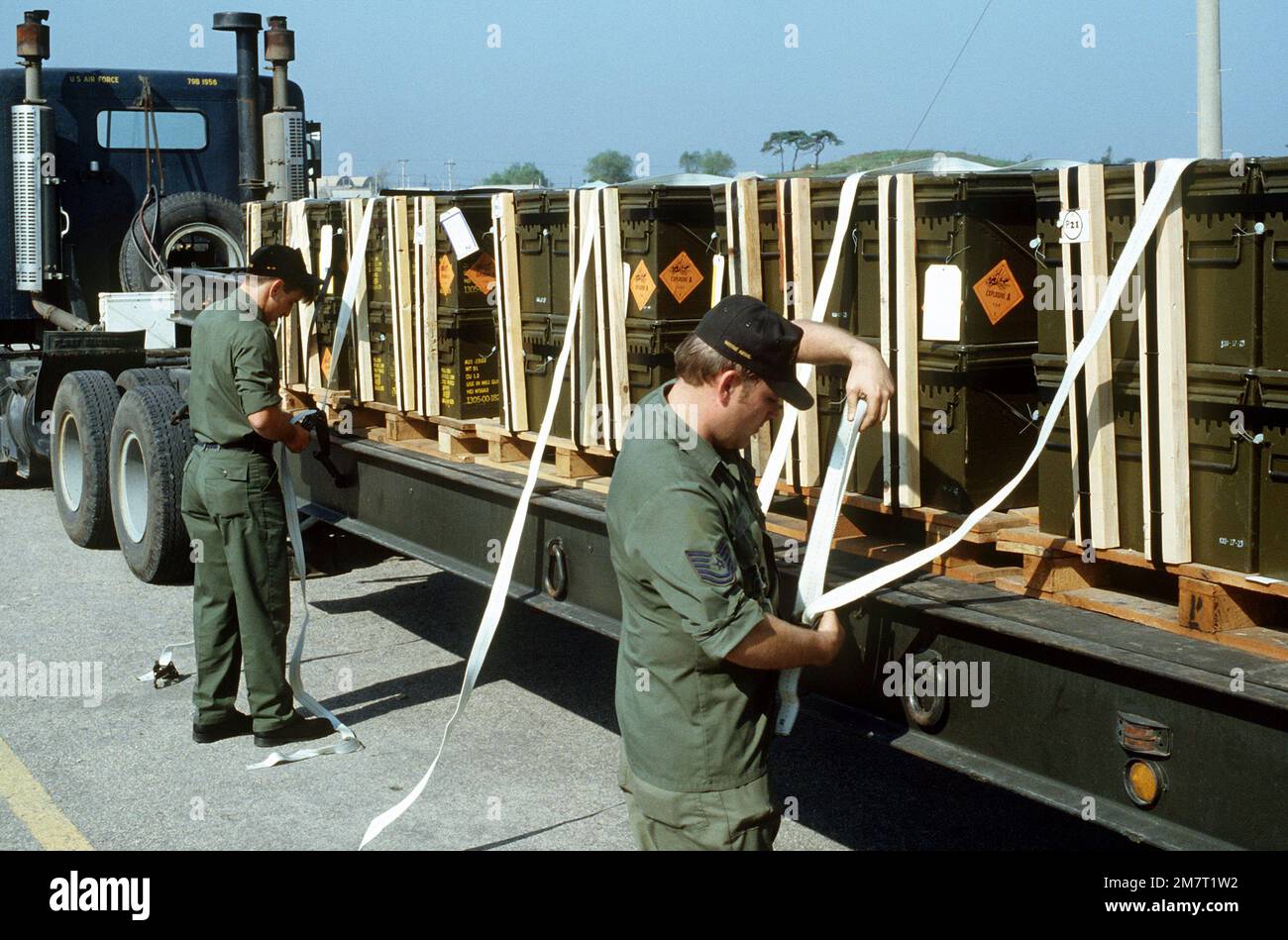 Cargo is tied down to a flatbed railroad car after its delivery. It ...
