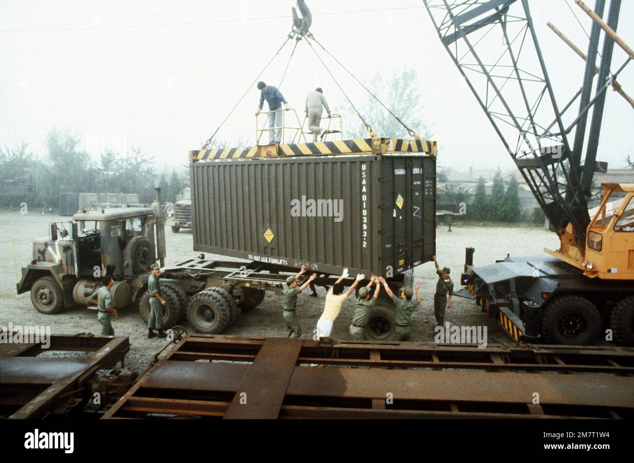 Military vans are transferred to Army trailers from the Army 25th ...
