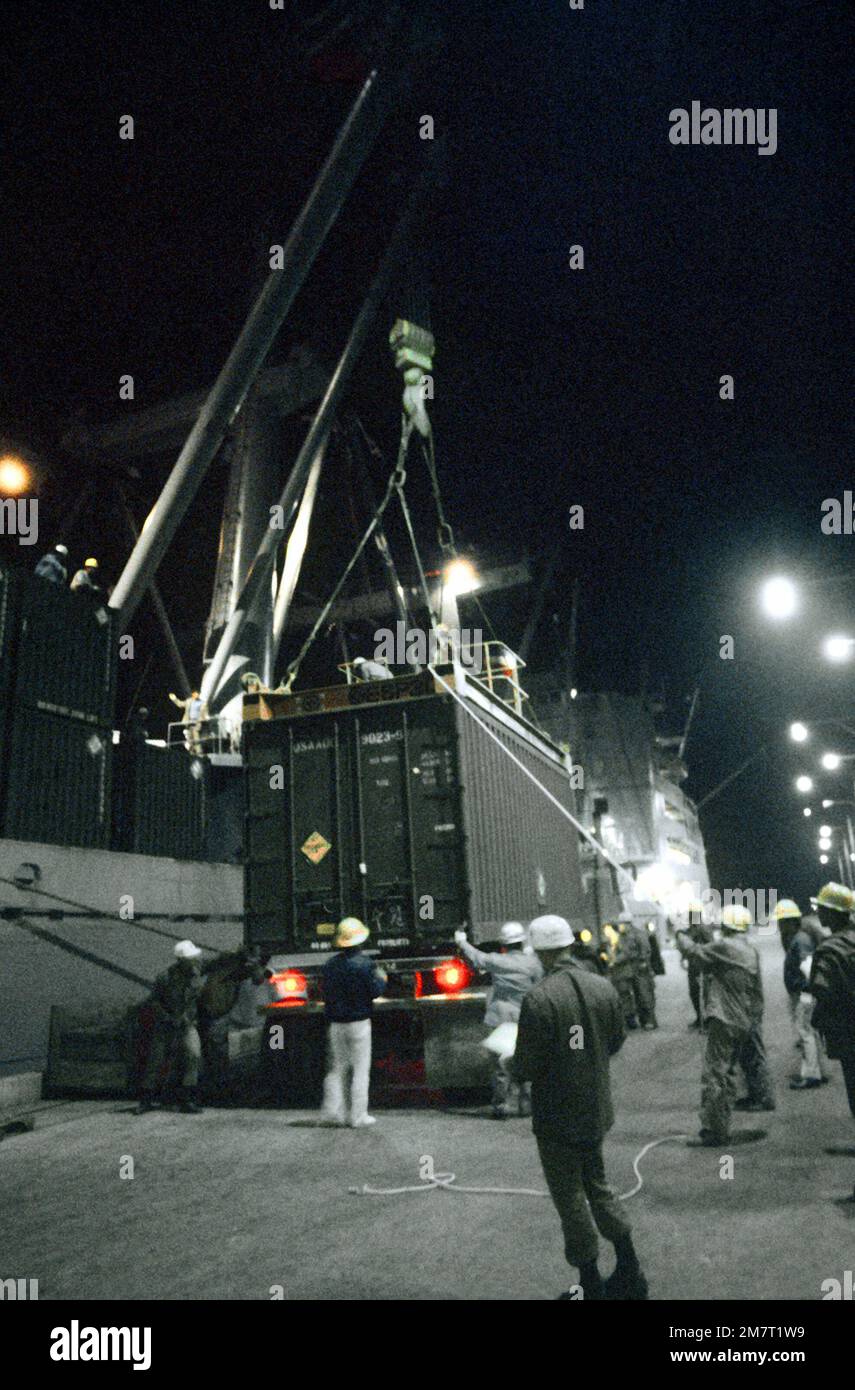 A military van containing munitions is transferred by crane from the ...