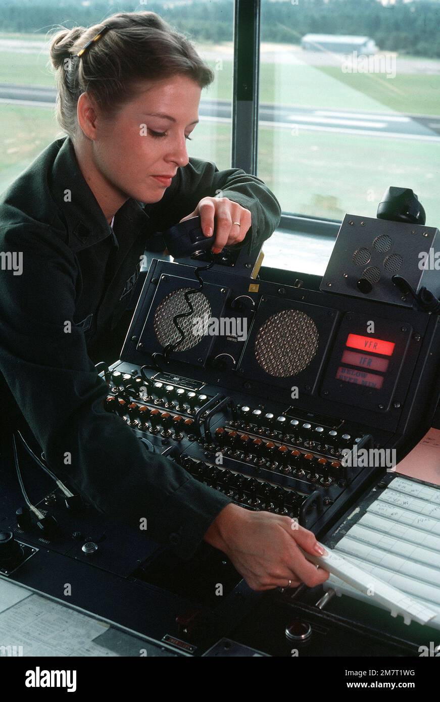 A female U.S. Army air traffic controller at work in a control tower ...