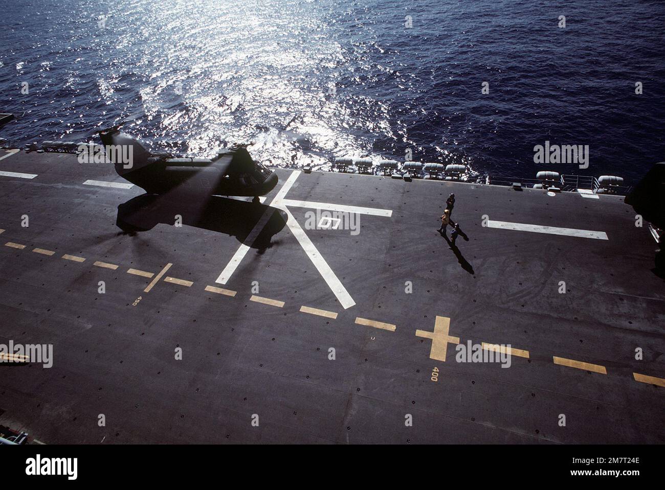 A CH-46 Sea Knight helicopter prepares for lift-off aboard the ...