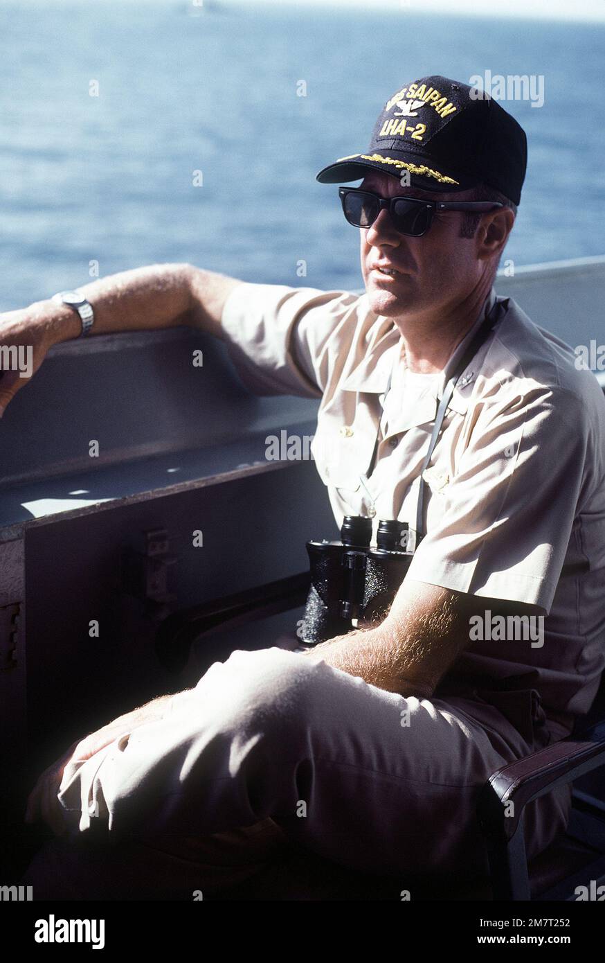 CAPT J. W. Renard, commanding officer, relaxes for a moment aboard the ...