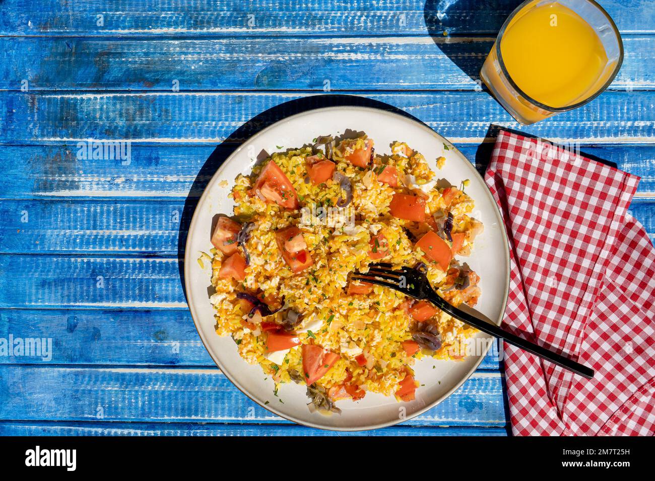 Plate with homemade chicken salad, carrot, tomato and brown rice on a ...