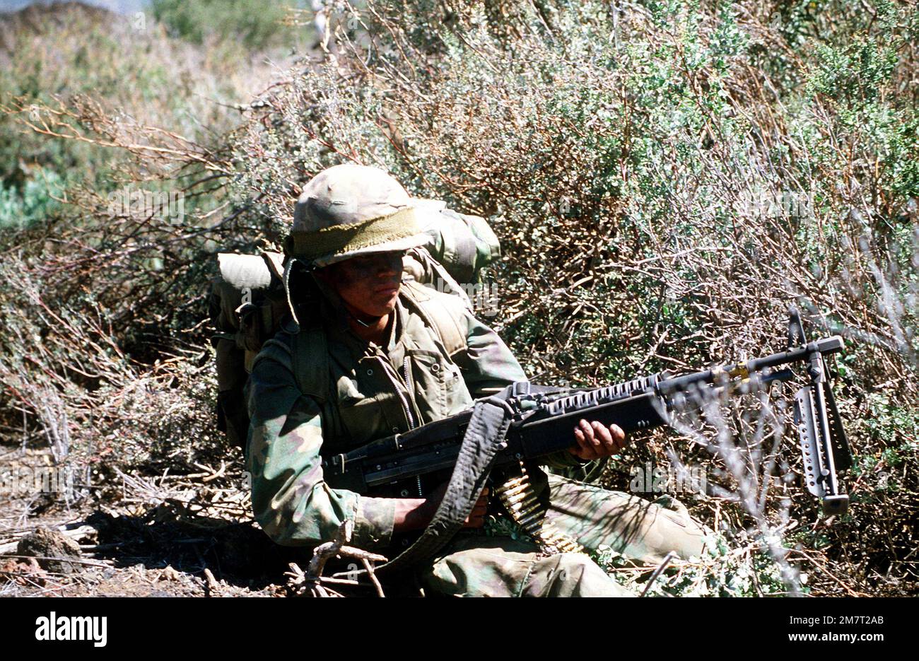 A Marine armed with an M-60 machine gun, guards his part of the ...