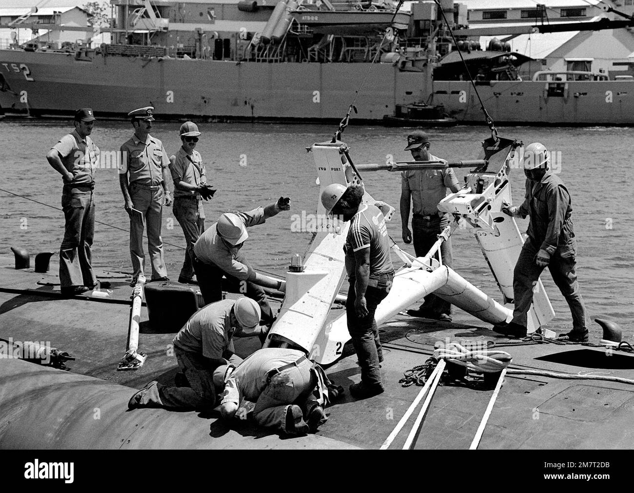 Civilian and Navy shipyard personnel secure the pylon on the nuclear ...