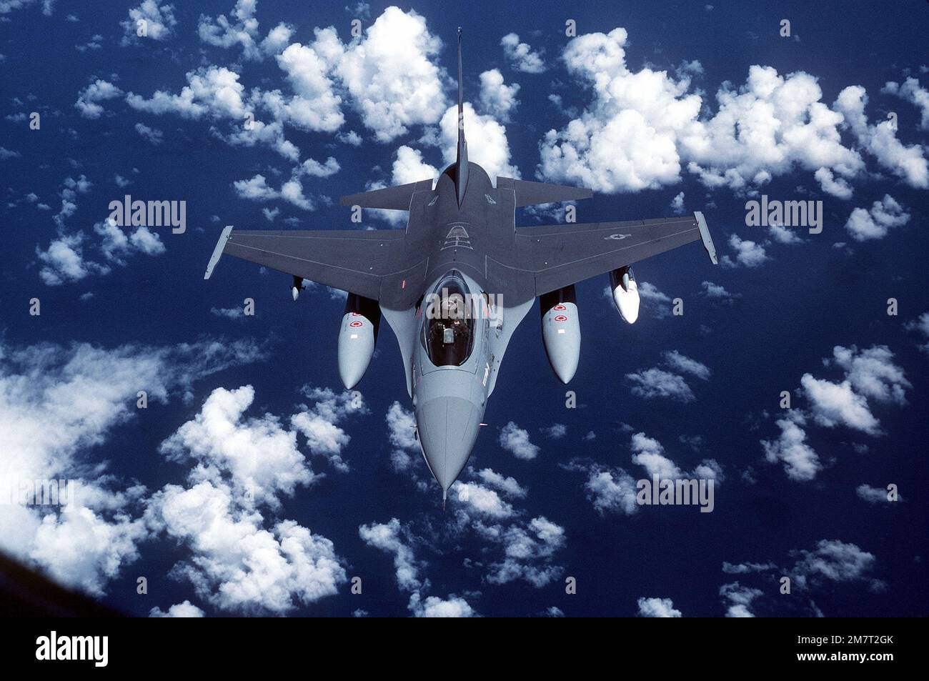 An air-to-air front view of an F-16 Fighting Falcon aircraft painted in ...