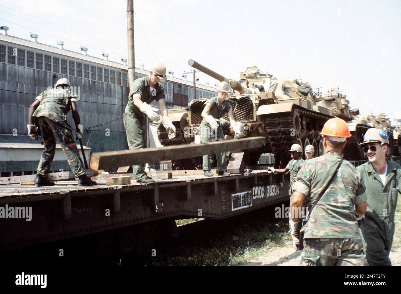 Marines prepare to offload an M-60A1 tank from a railroad flatcar to be ...