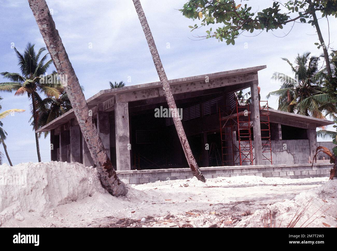 A partially-constructed building near palm trees. Base: Nav Sup ...