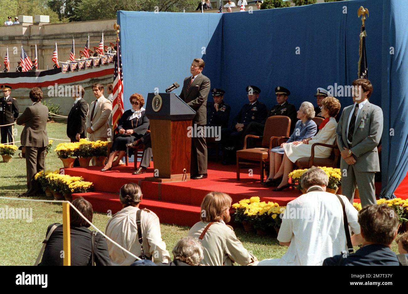 President Ronald Reagan speaks to an audience as Mrs. Douglas MacArthur ...