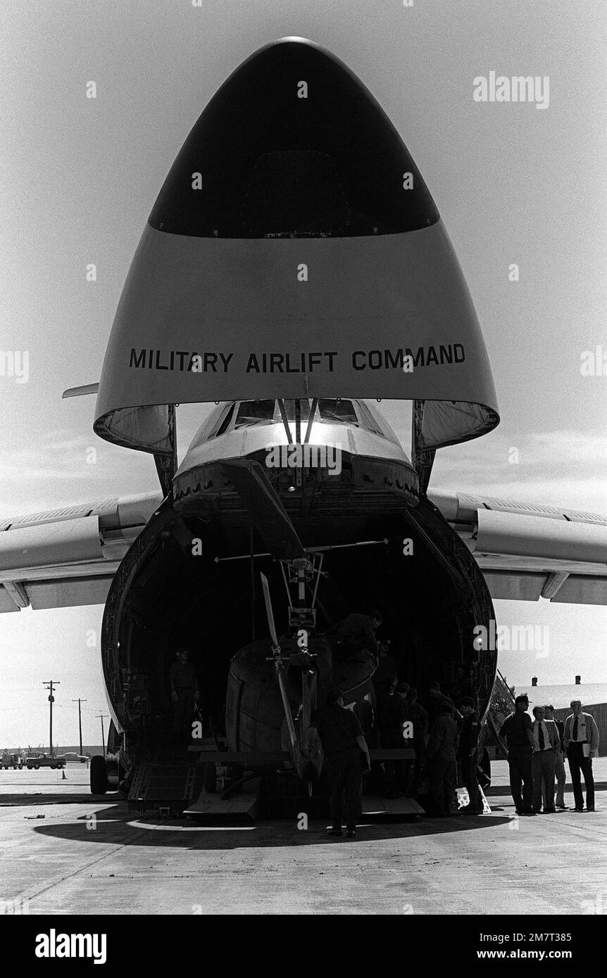 An Army helicopter is being loaded aboard a C-5A Galaxy aircraft during ...