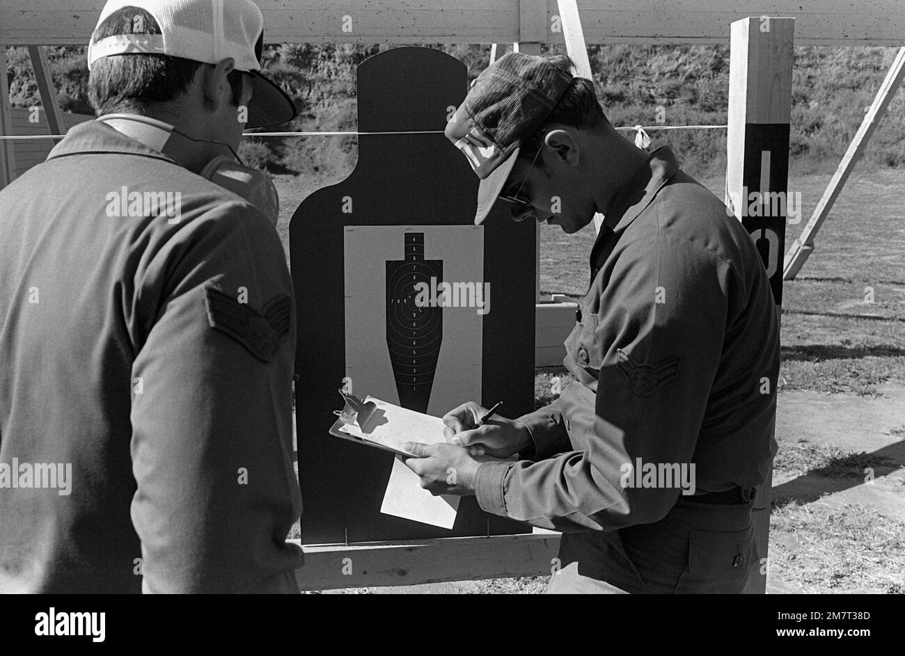 A1C Howard Burkett, a block instructor at the firing range, checks and ...