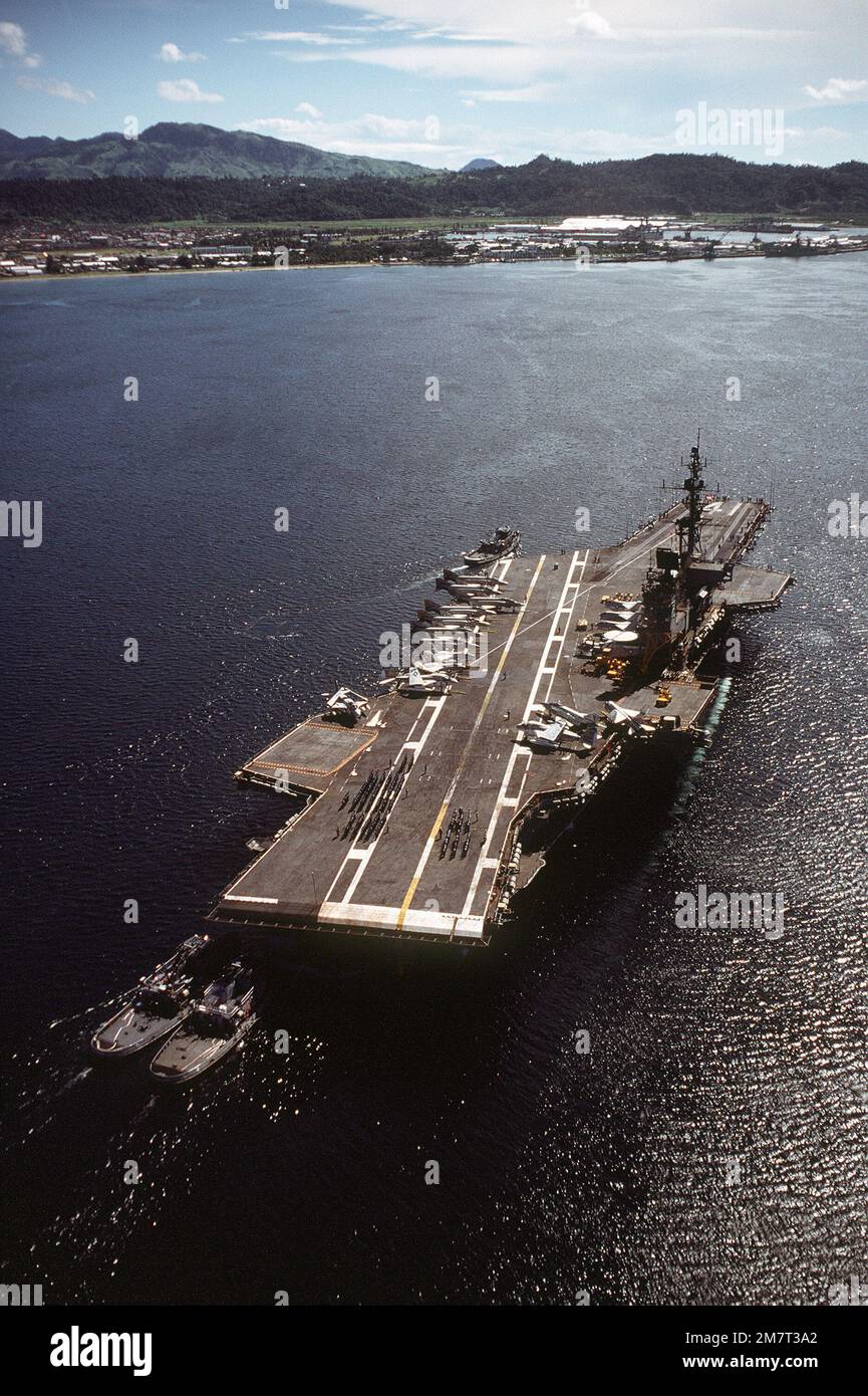 A high-angle starboard quarter view of the aircraft carrier USS MIDWAY ...