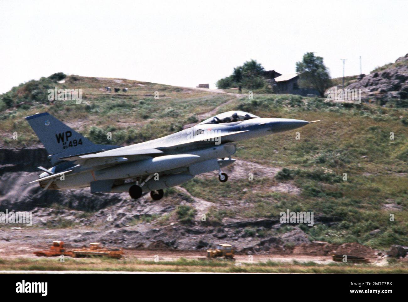 Right side view of an F-16 Fighting Falcon aircraft landing to join its ...