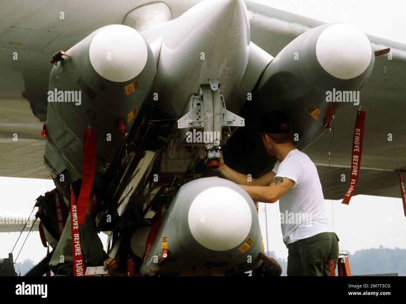 A missile crewman from the 416th Bomb Wing, inspects three Air-Launched ...