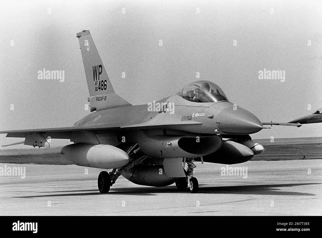 A right front view of an F-16 Fighting Falcon aircraft displayed on the ...