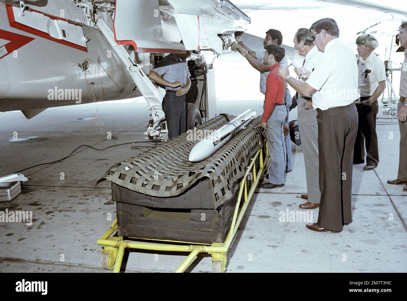 Personnel check on an F-14A Tomcat aircraft after an advanced medium ...