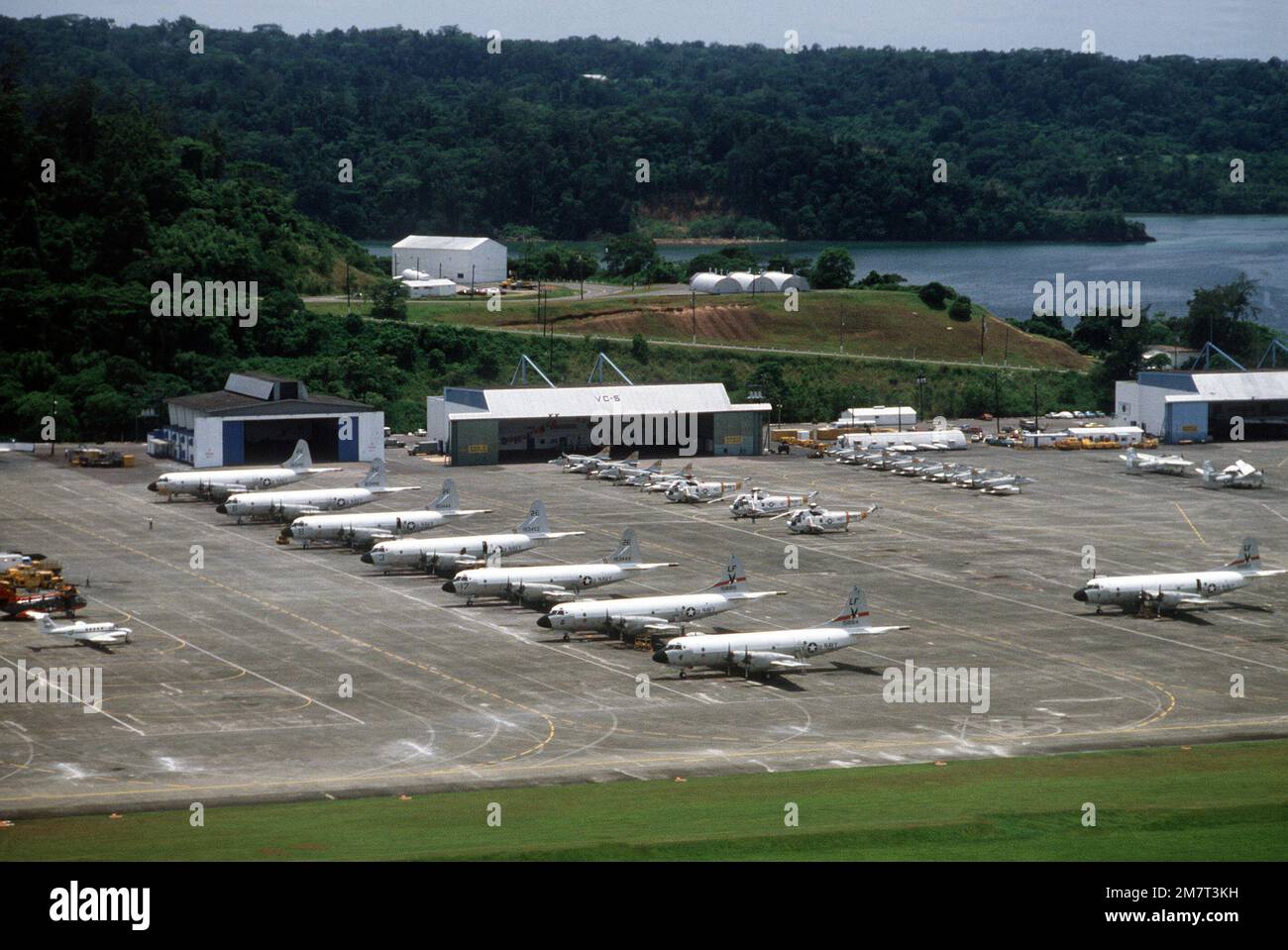 An aerial view of aircraft parked on the flight line in front of a ...
