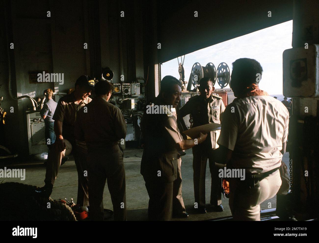 U.S. and Philippine naval officers aboard the ammunition ship USS MOUNT ...
