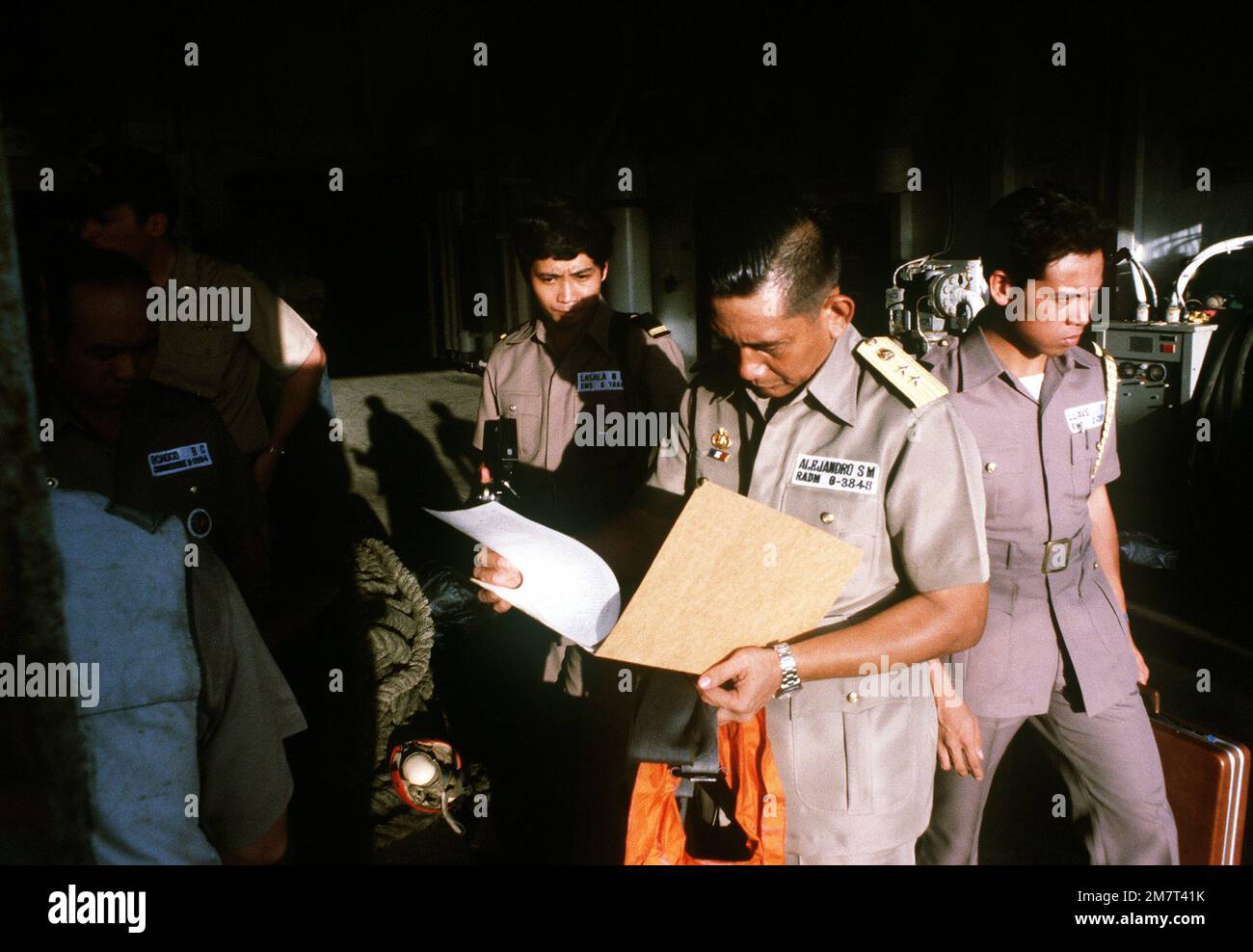U.S. and Philippine naval officers aboard the ammunition ship USS MOUNT ...