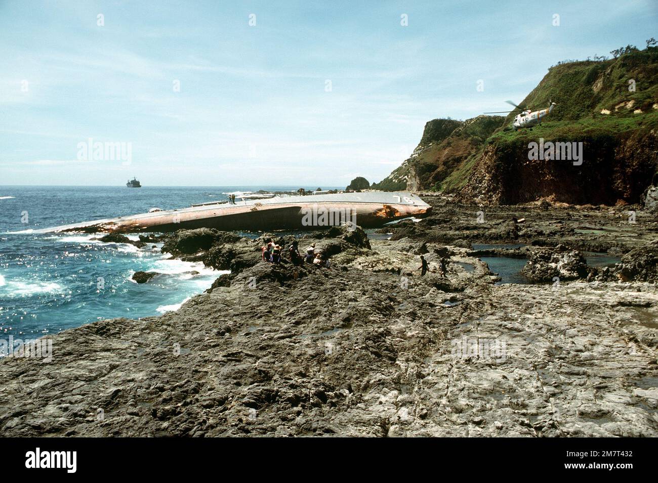 Crewmen from the ammunition ship USS MOUNT HOOD (AE-29), standing ...