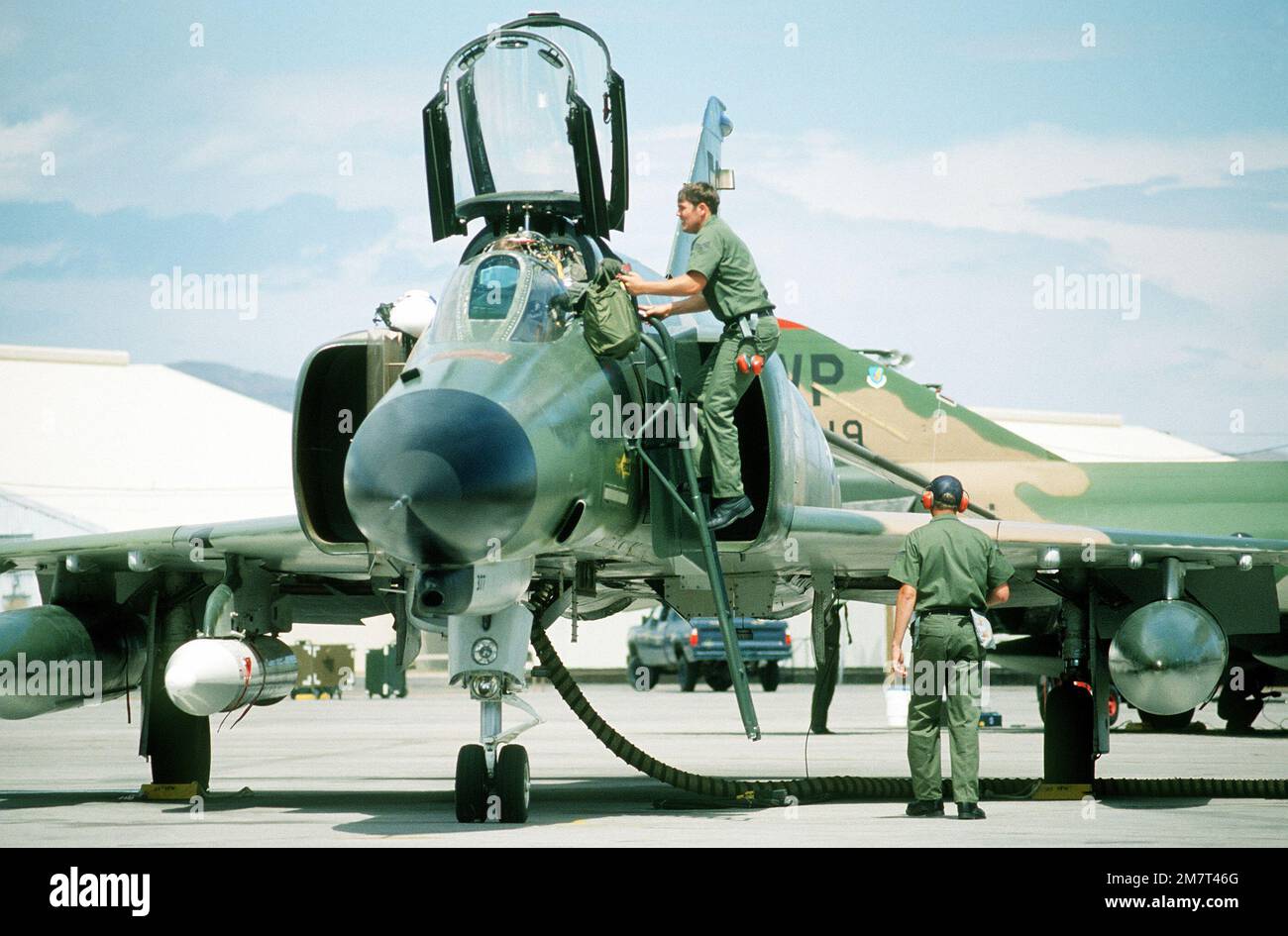 An F-4 Phantom II aircraft is met by the ground crew after landing ...