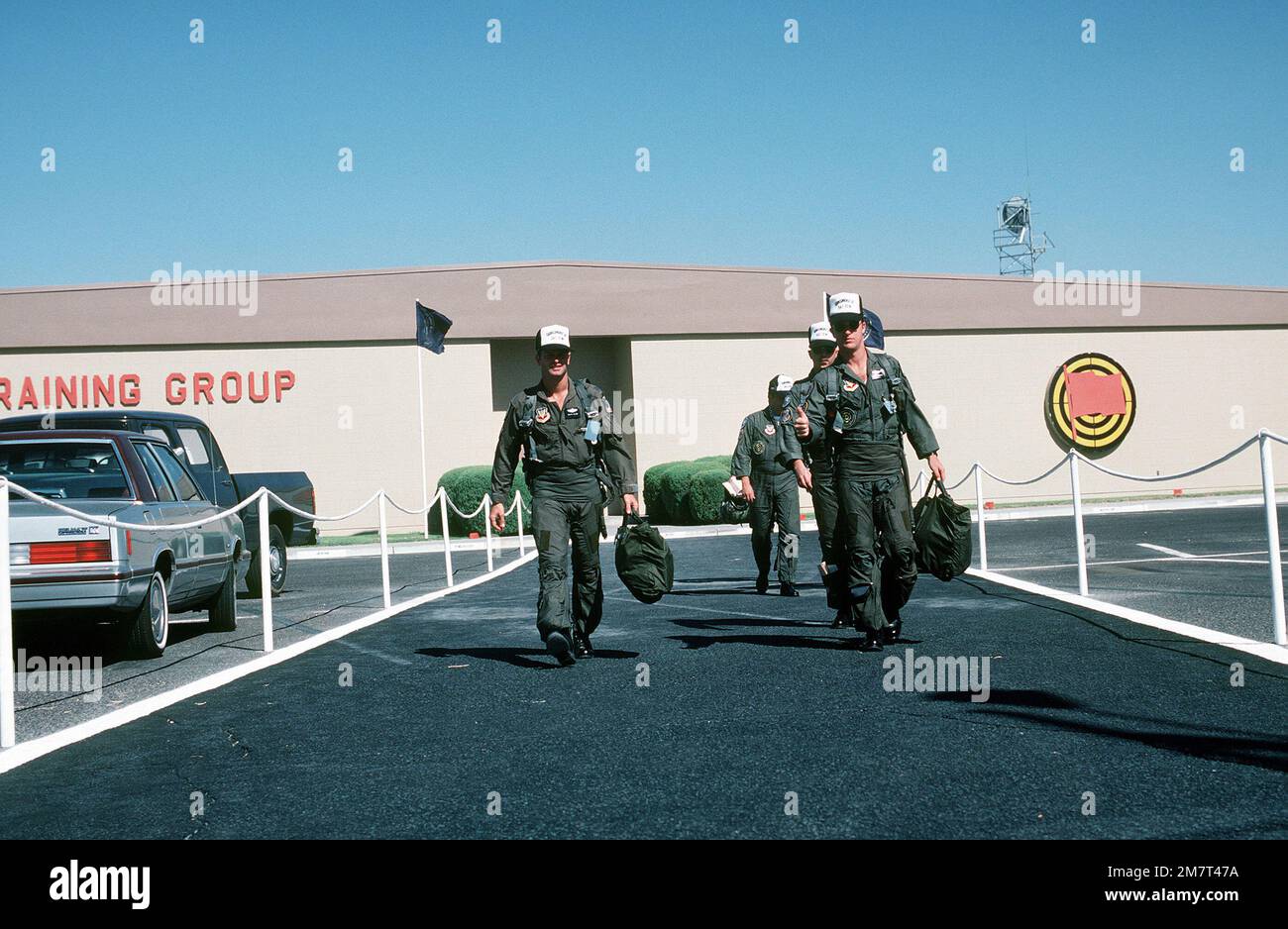 Pilots exit the 4440th Tactical Fighter Training Group headquarters en ...