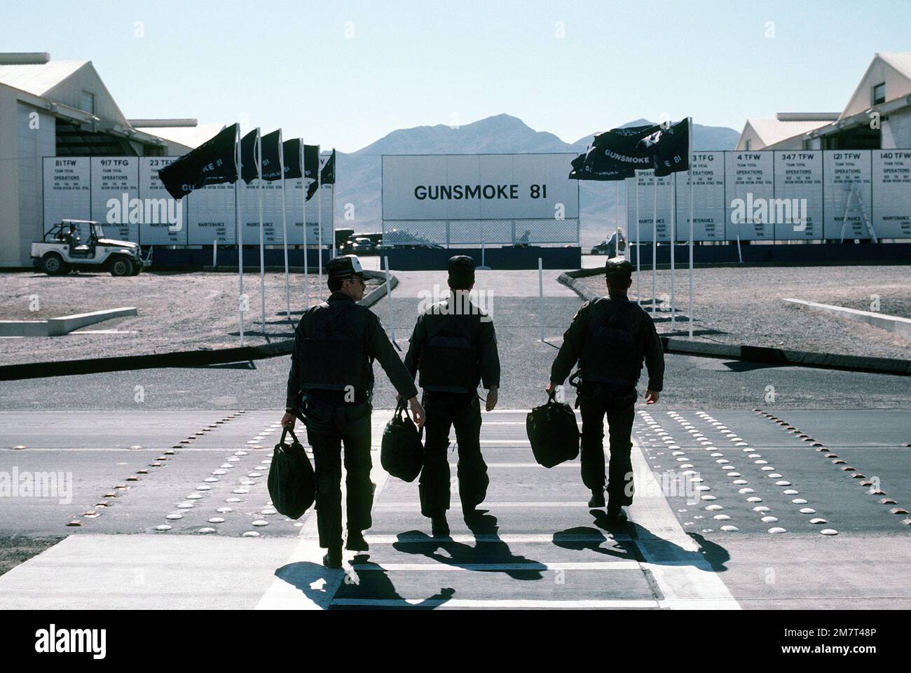 Pilots approach the flight line during Operation Gunsmoke '81. Subject ...