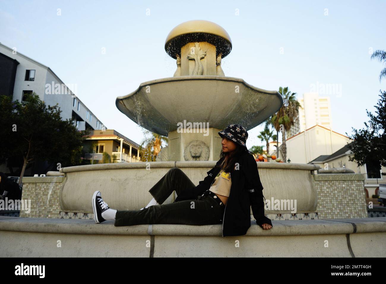 The model is placed in front of a fountain shot with low shutter speed ...