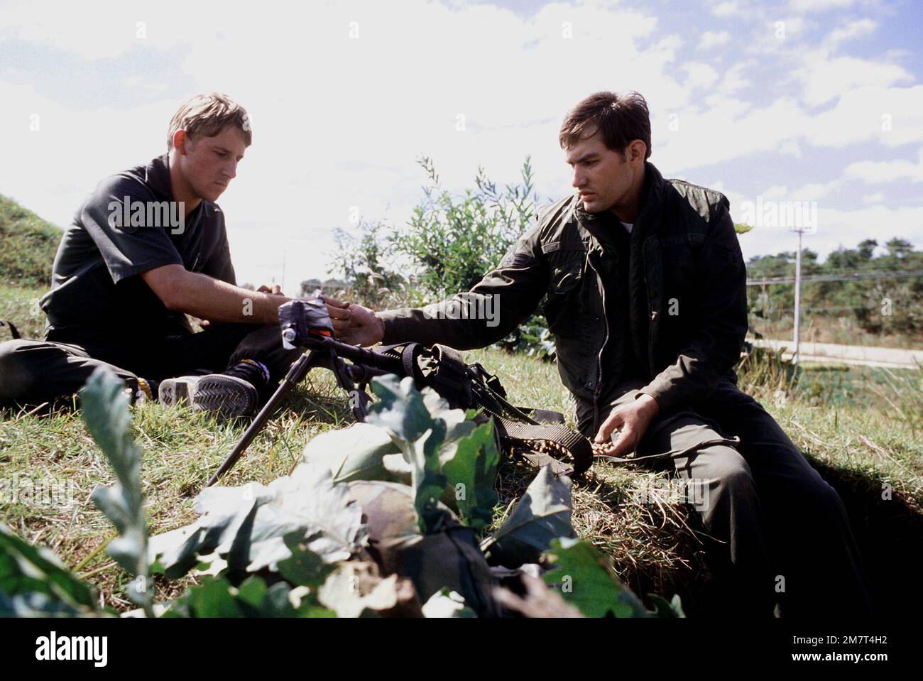 AMN Tom Gogel instructs SGT James Smith to load an M-60 machine gun ...