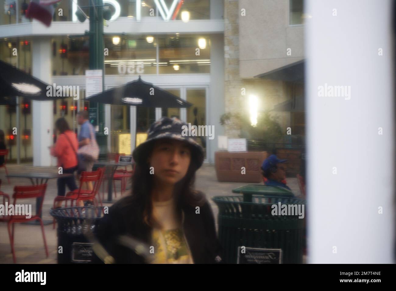 This photo is taken with the model in the background of a reflection ...