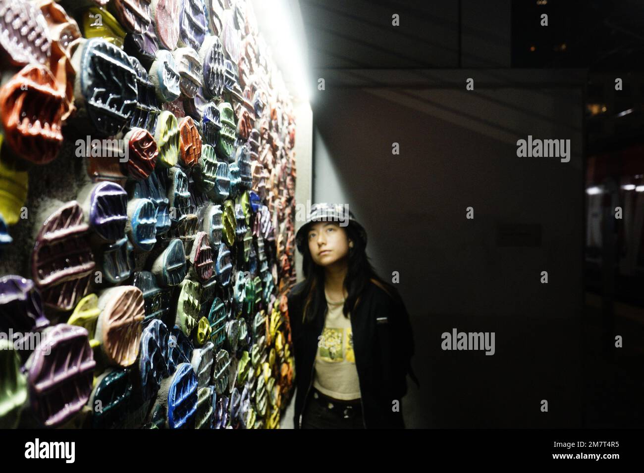 The model is placed under a light with the model in focus. Shot at low ...