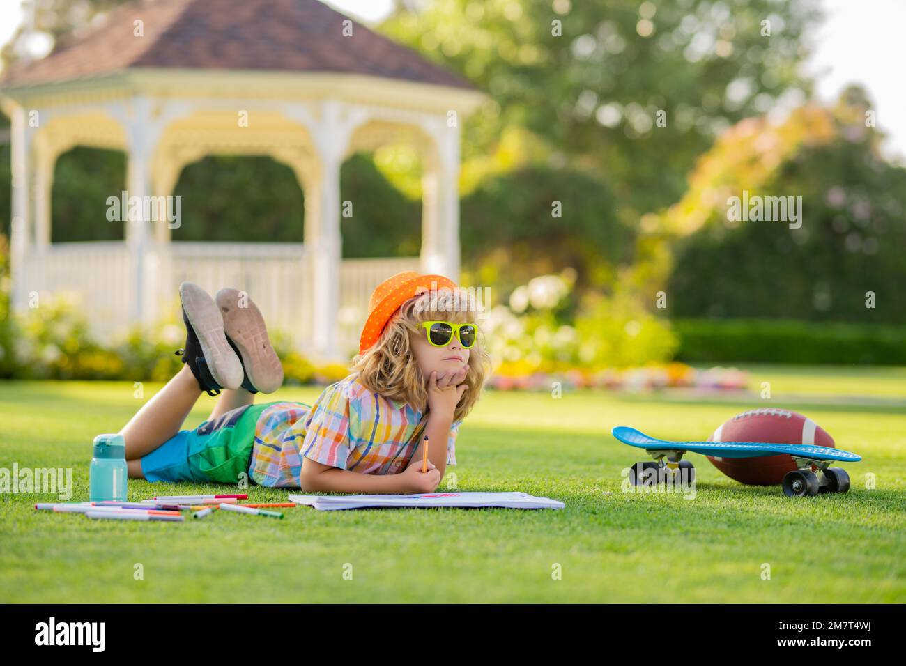 Child play and draw craft artwork homework. Clever school boy doing ...