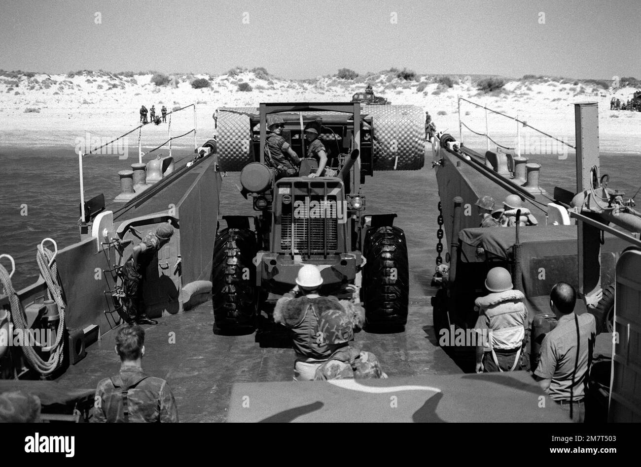A Marine backs a forklift onto a mechanized landing craft (LCM-8) prior ...