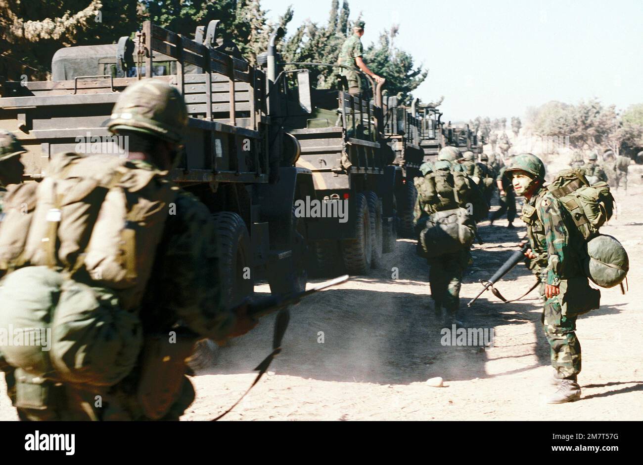 Army personnel from Fort Ord, California, move in formation along a ...