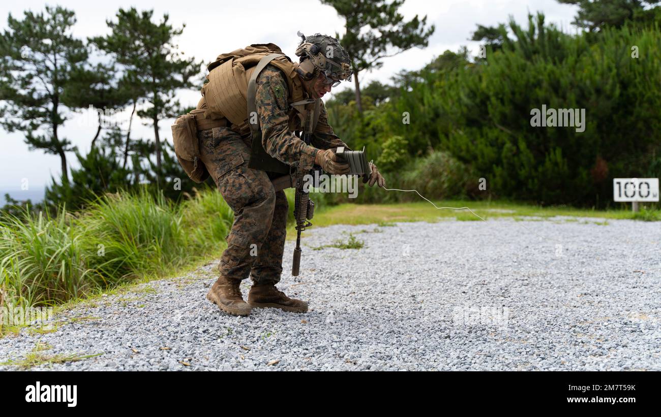 A U.S. Marine with 3d Battalion, 2nd Marines places an M18 Claymore ...