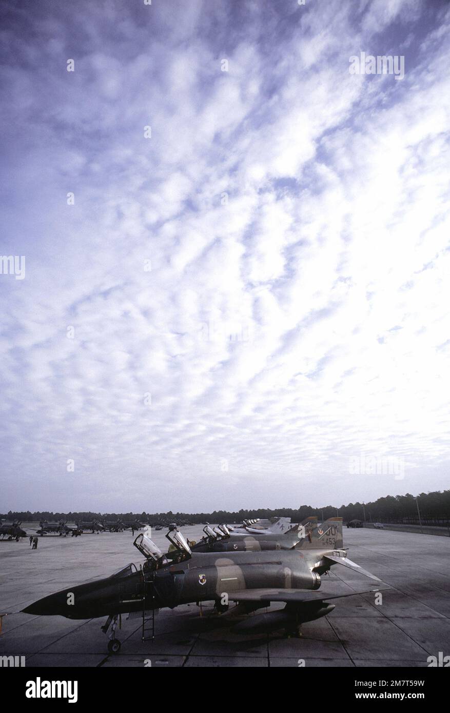 A side view of F-4 Phantom II aircraft on the flight line during ...