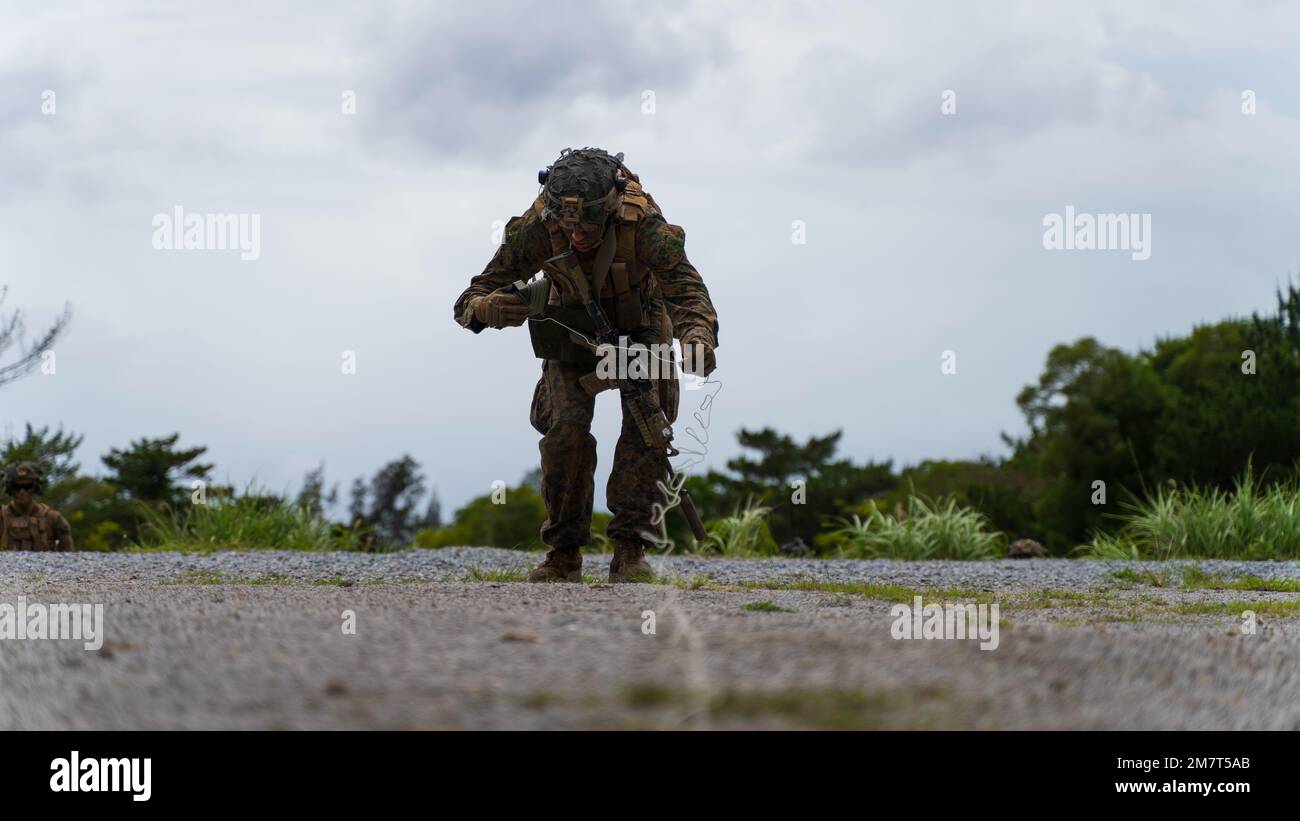 A U.S. Marine with 3d Battalion, 2nd Marines places an M18 Claymore ...