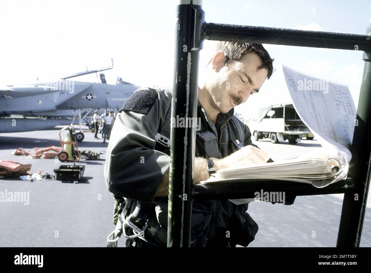 A pilot from the 12th Tactical Fighter Squadron makes a final entry in ...