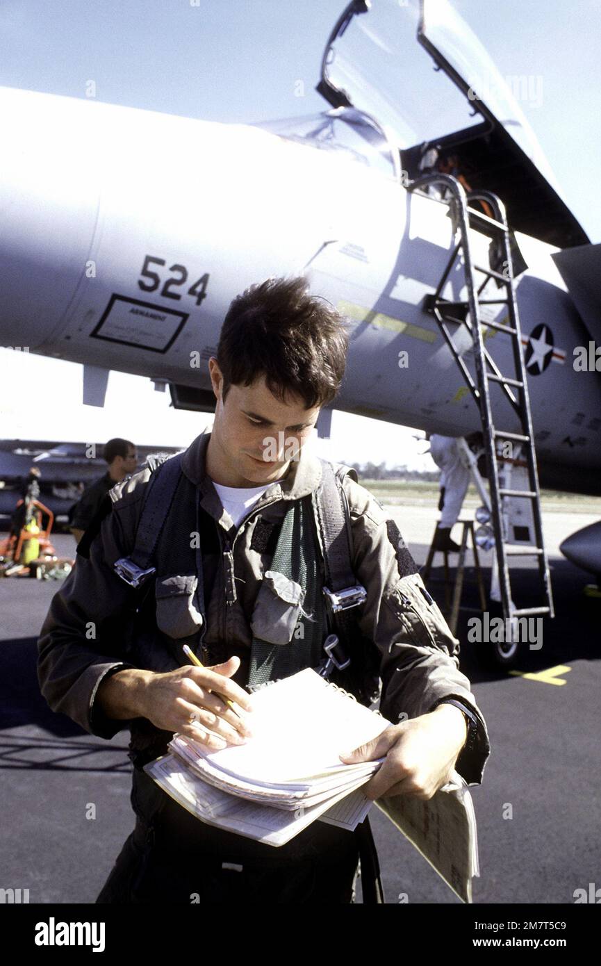 A pilot from the 12th Tactical Fighter Squadron makes a final entry in ...