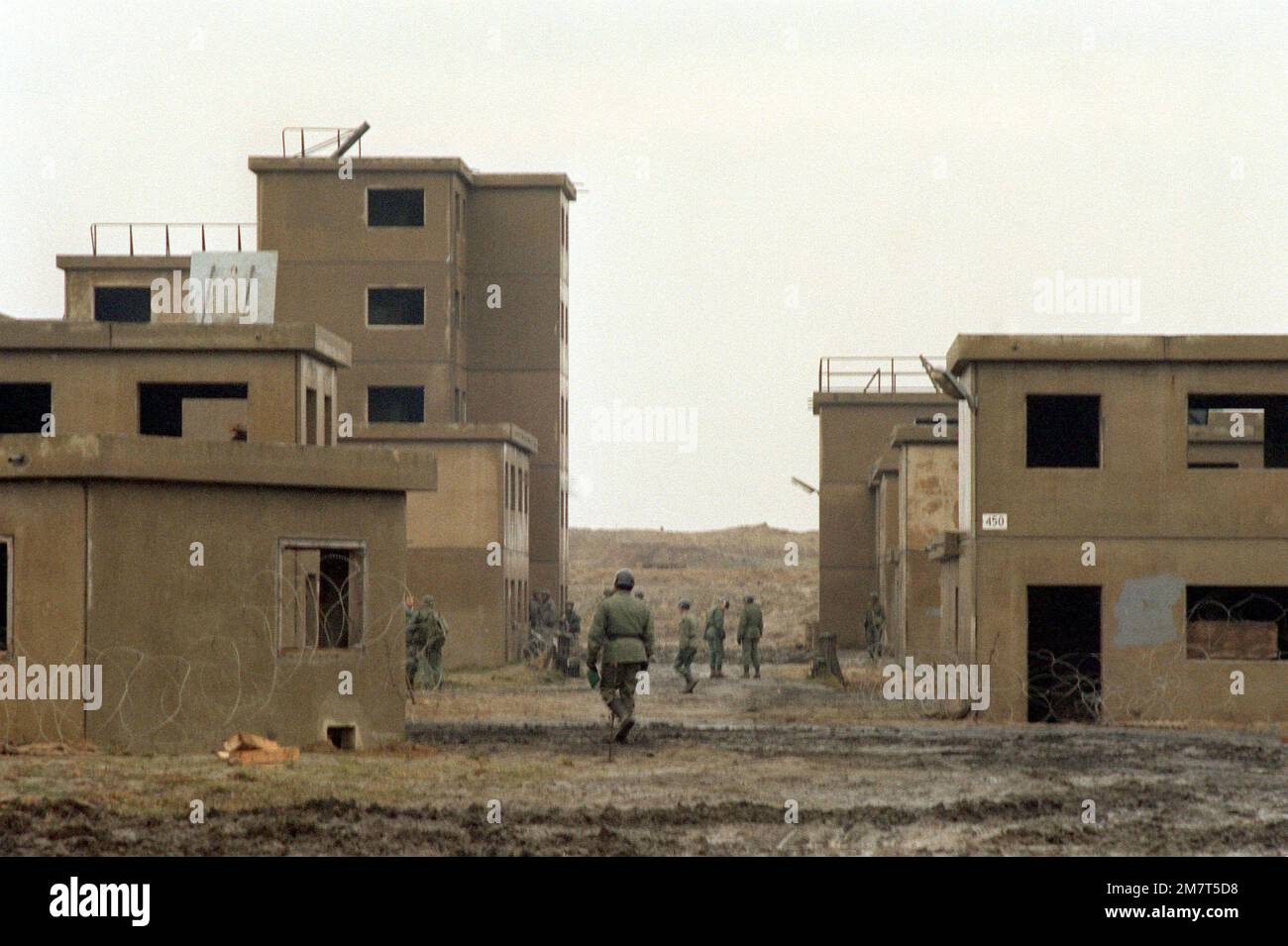 Members of the 1ST Armored Cavalry move through a simulated town during ...