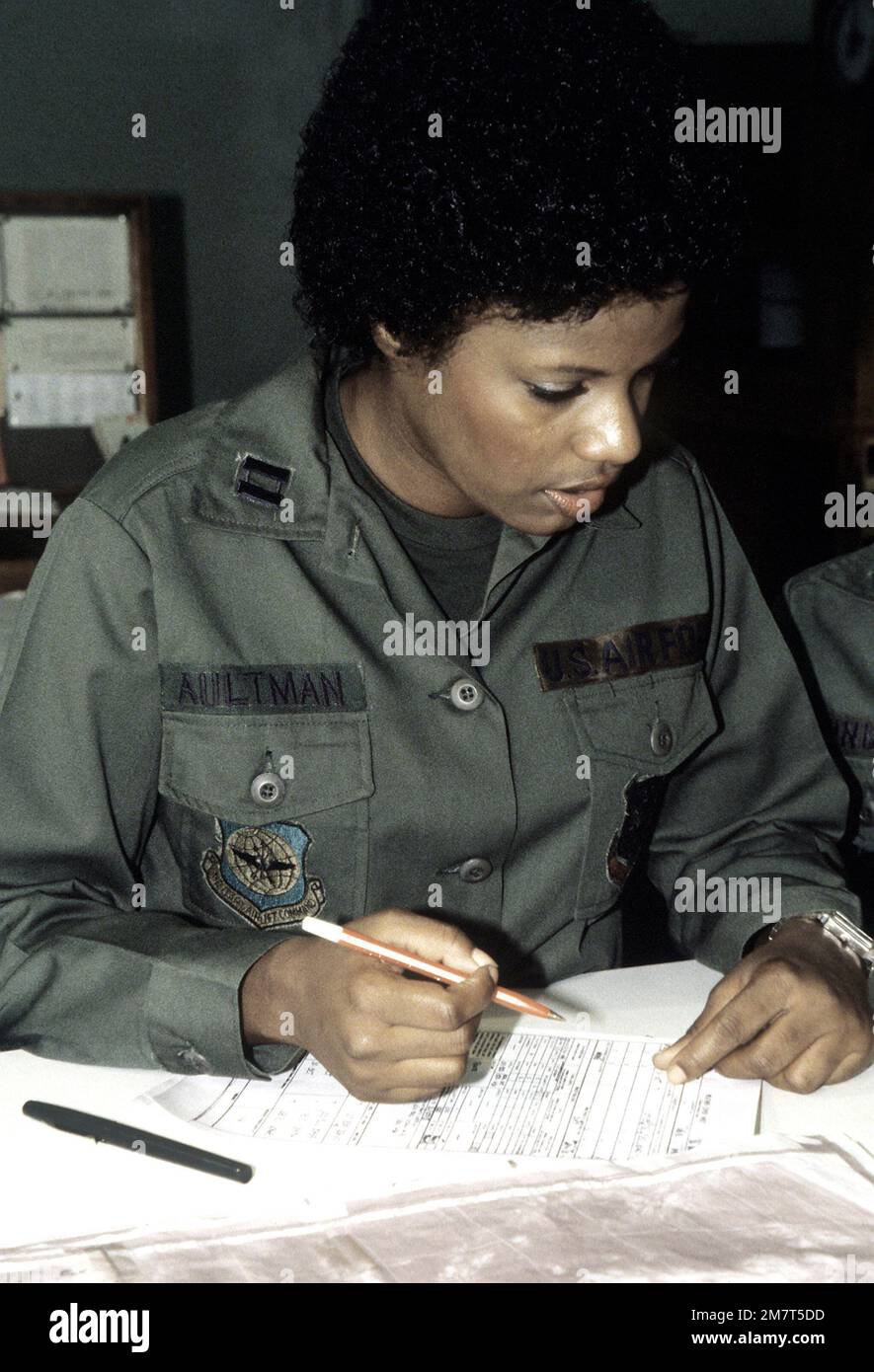 CPT Cheryl Aultman, from the 1ST Weather Wing, Detachment 8, works on a ...