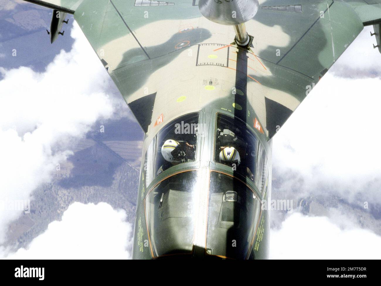 Top view of a Royal Australian Air Force F-111 aircraft being refueled in flight by a KC-135 ...