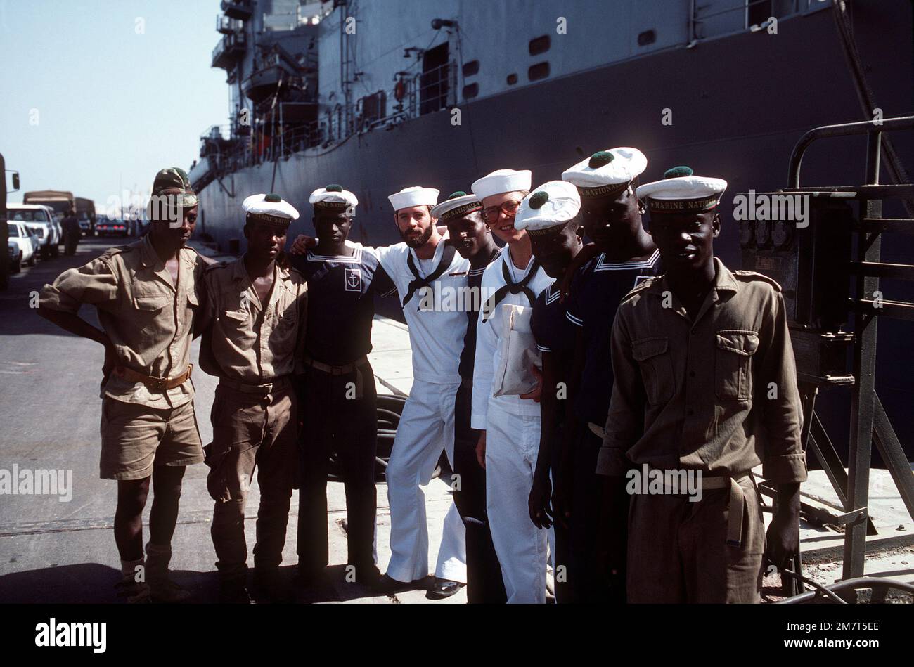 Crewmen from the destroyer USS ARTHUR W. RADFORD (DD-968) stand with ...