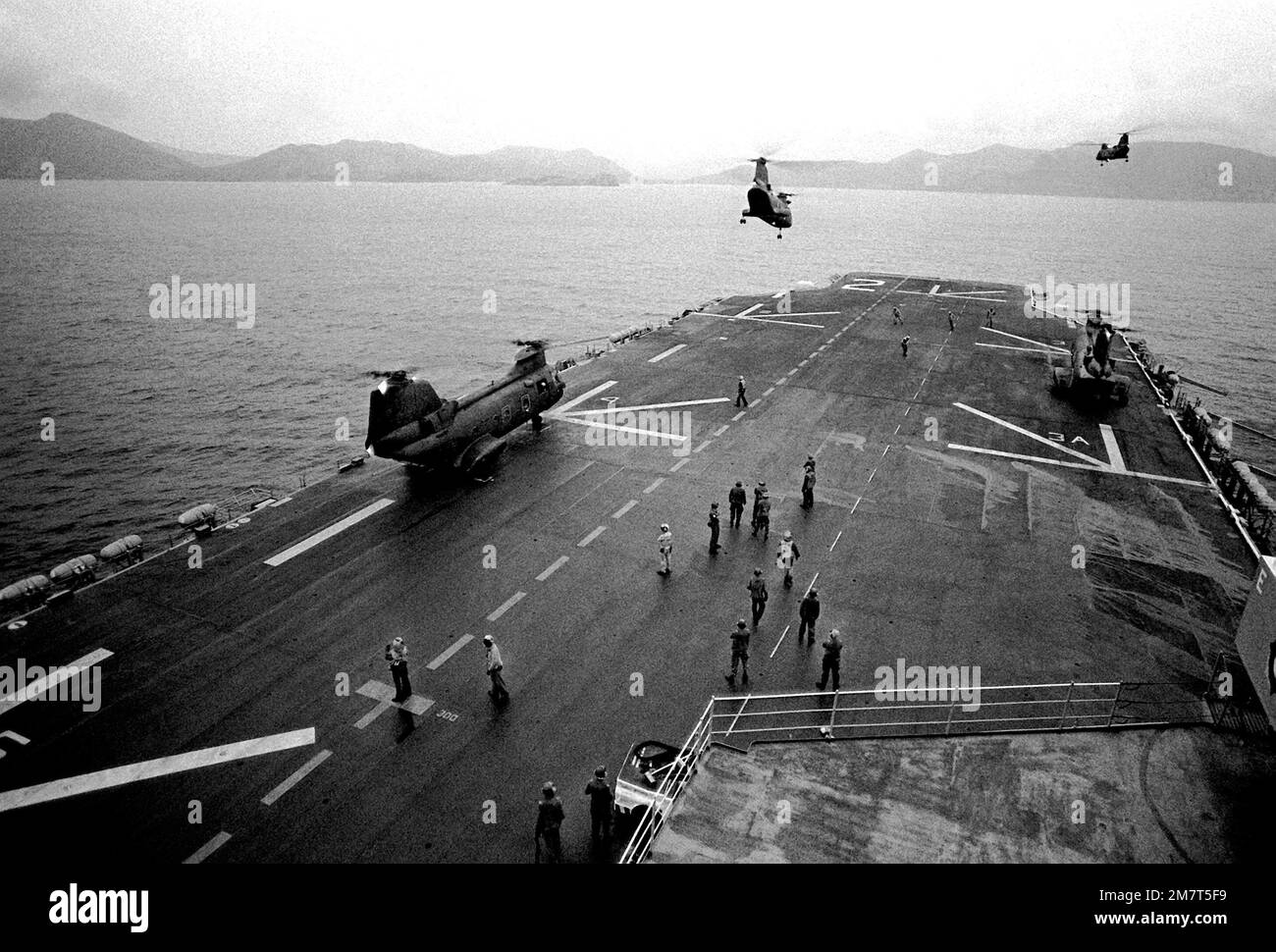 Two CH-46 Sea Knight helicopters lift off the deck of the amphibious ...