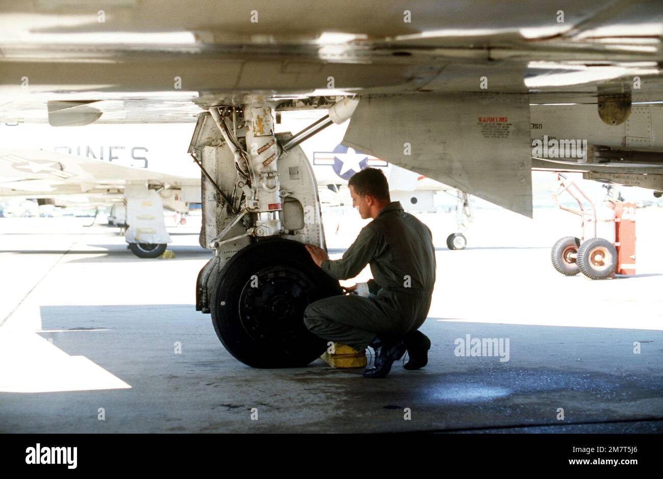 Sergeant Arnold of Marine Aircraft Group 41 works on an F-4 Phantom II ...